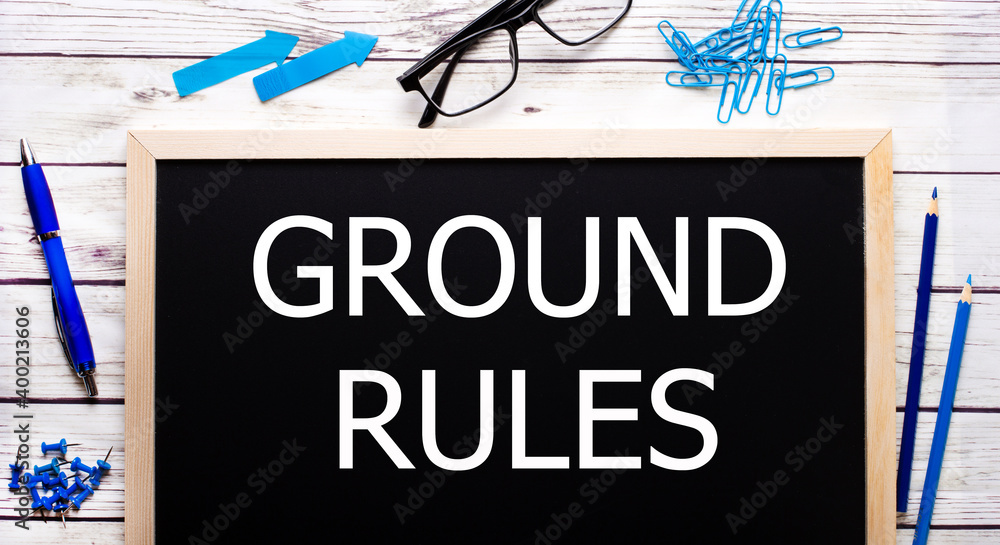 GROUND RULES written on a black note-board next to blue paper clips ...