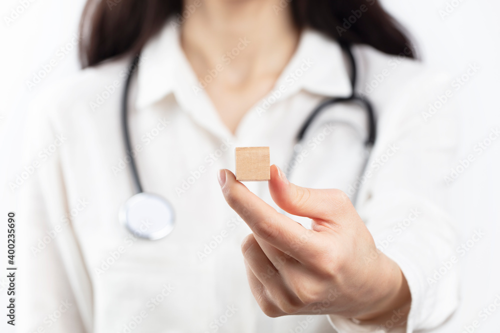 wooden cube blocks in doctor's hands. Banner poster for advertising and ...