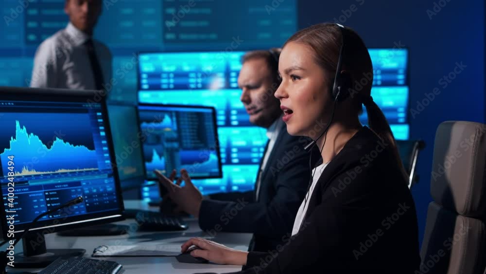 Team of brokers is working in office using workstation and analysis ...