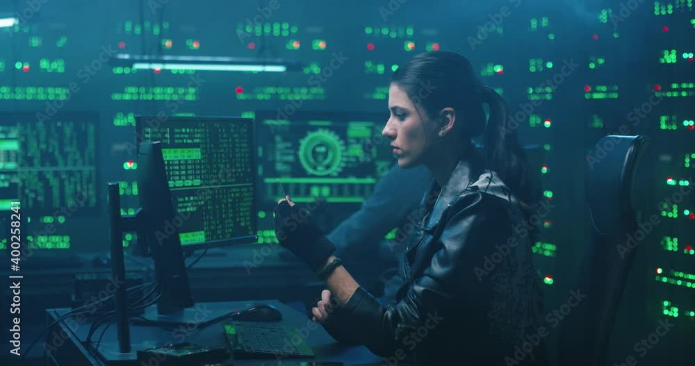 Young beautiful caucasian girl hacker in leather jacket sitting at ...