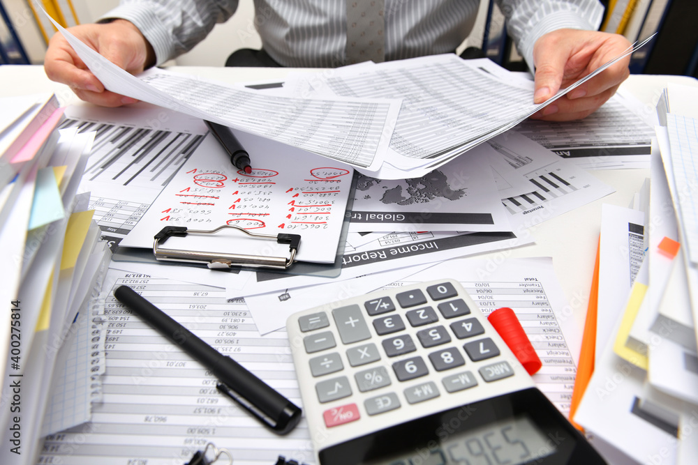 business concept - businessman working with reports in office, table ...