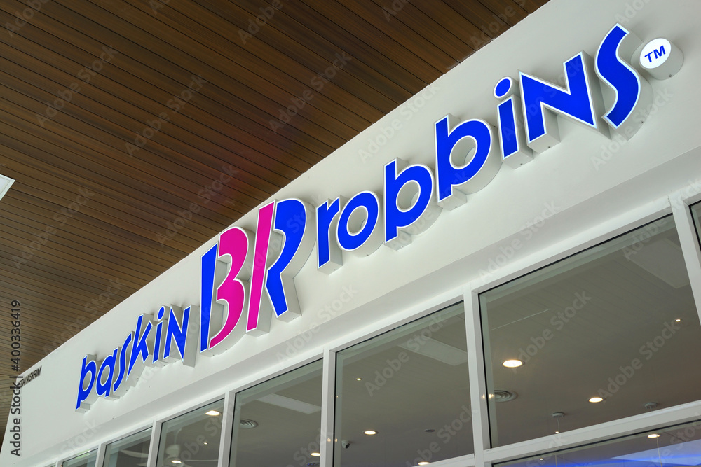 Baskin Robbins sign is attached to the exterior wall over the entrance ...