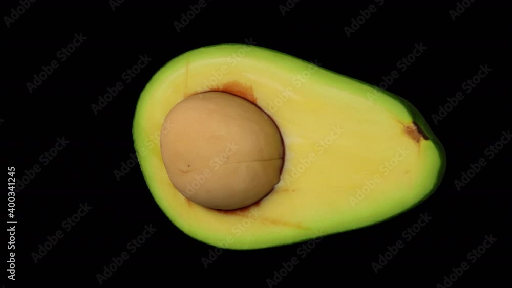 Realistic render of a rotating green Florida avocado (cut in half with ...