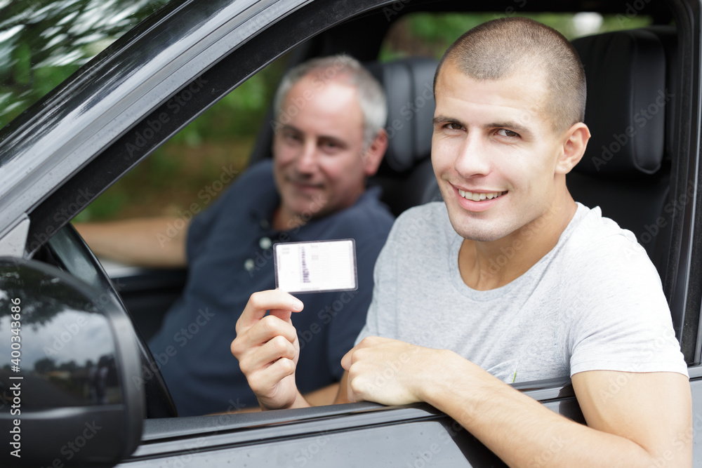 happy young successful man showing his new european driving license ...