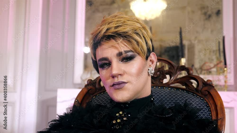 Face portrait transsexual proud looking at camera close up. Queer ...