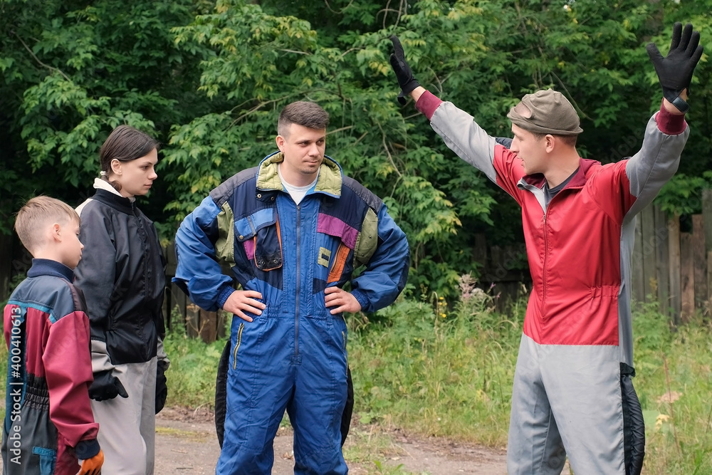 Man instructor gives instructions to the family before the flight in ...