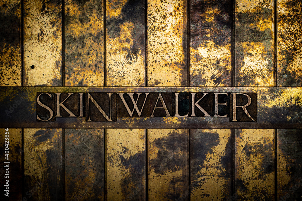 Skinwalker text on grunge textured copper and gold background Stock ...
