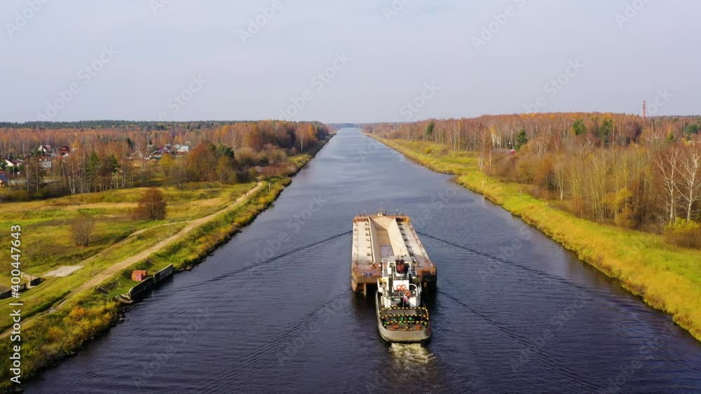 Aerial view of Barge on the river. River tugboat moves cargo barge ...