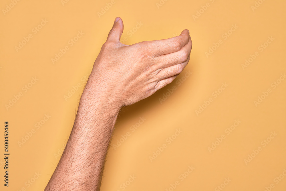 Hand of caucasian young man showing fingers over isolated yellow ...