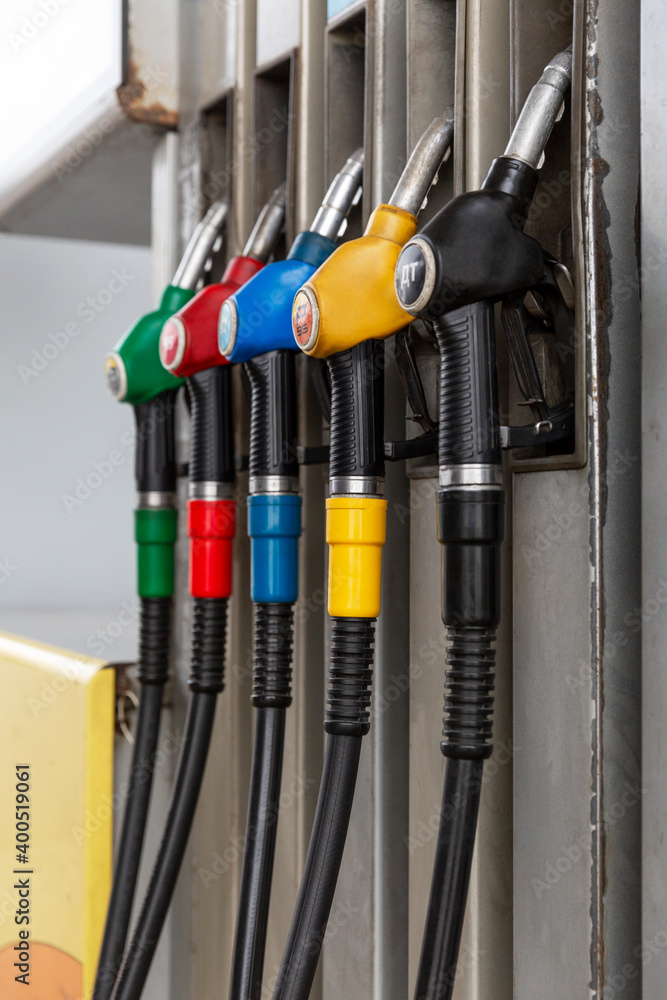 Pistols with different types of fuel at the gas station. Vertical ...