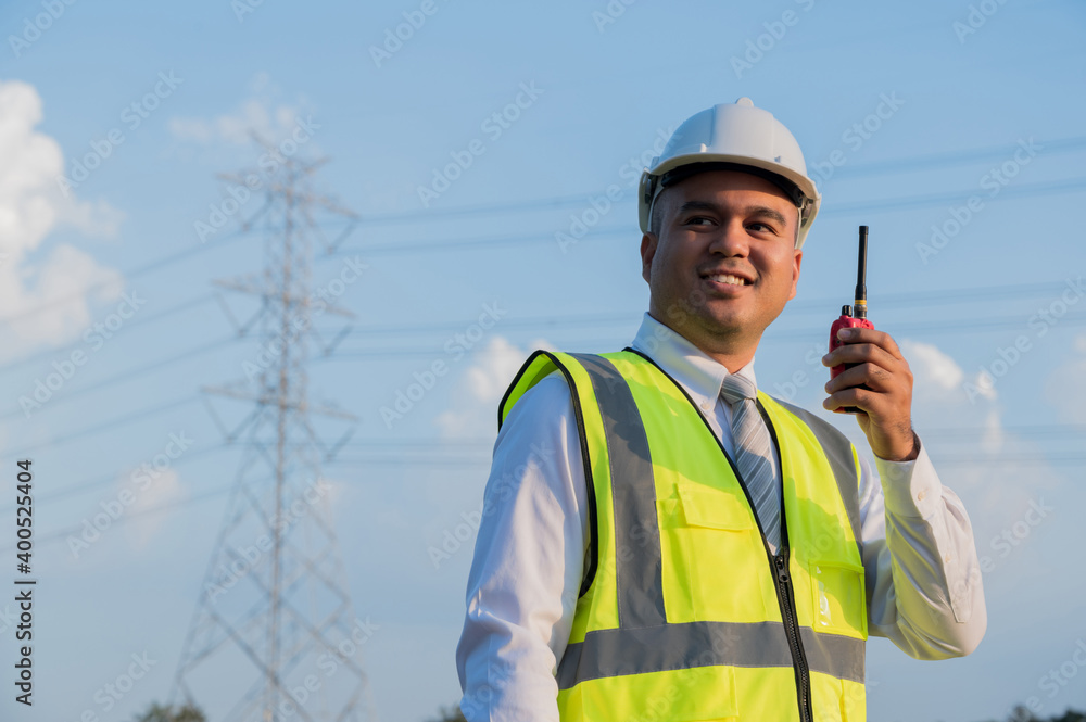 An Asian male engineer using a radio station is working in front of a ...