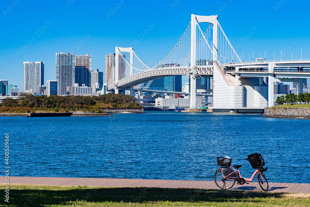 Bike on the background of Tokyo Bay and Rainbow bridge. White ...
