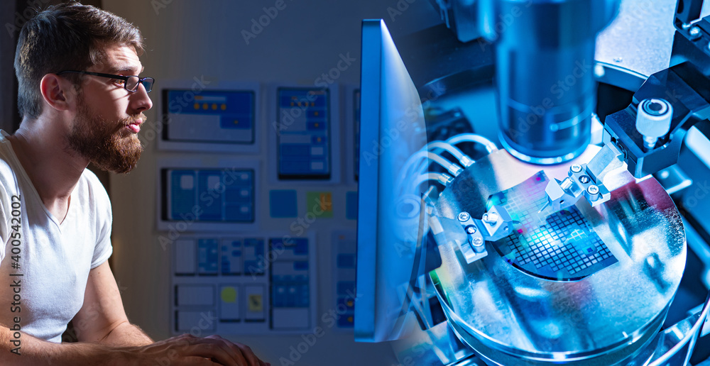 Microelectronics. Engineer works with an electron microscope. Concept ...