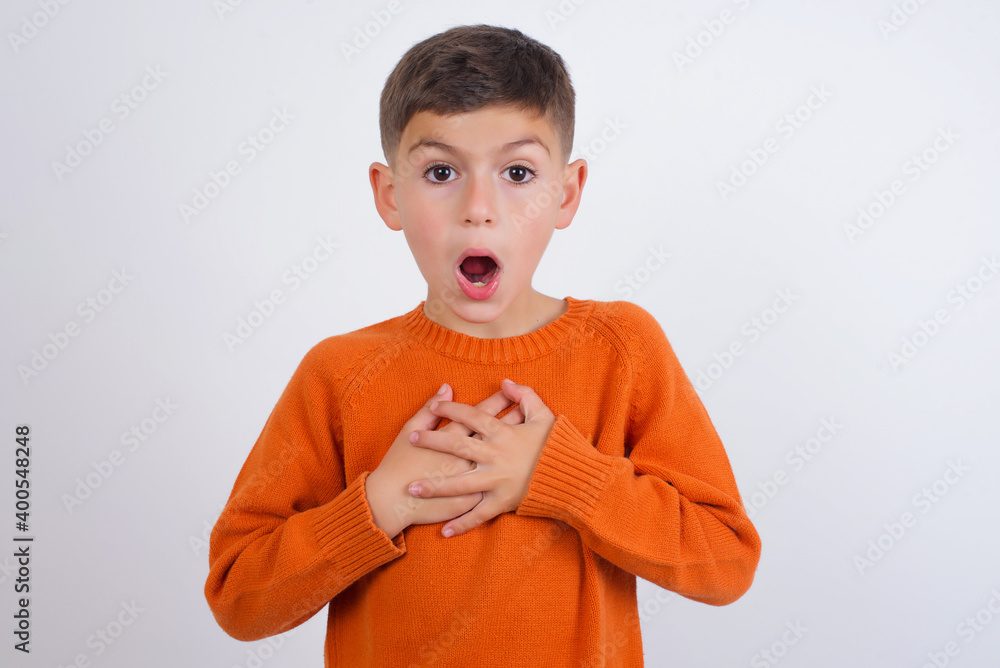 Scared Cute Caucasian kid boy wearing knitted sweater looks with ...