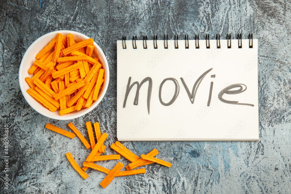 top view cheese rusks with movie written notepad on a light background ...