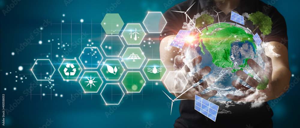 Man holding planet Earth with solar panels, fans and renewable energy ...