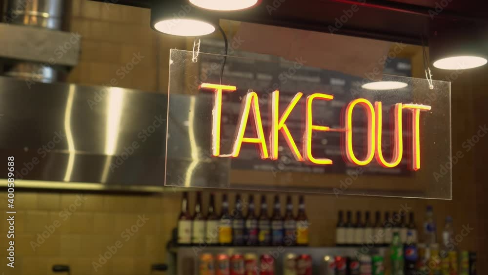 A cafe owner puts a TAKE OUT ONLY sign . Take out or carry away quickly ...