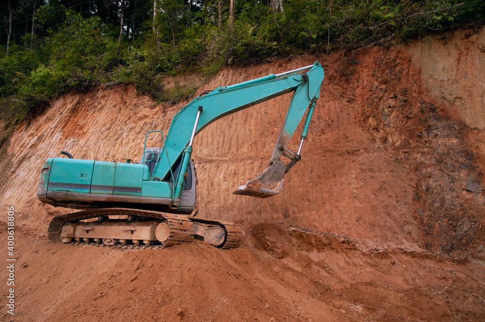 Excavator during excavation at construction site. Excavator digging ...