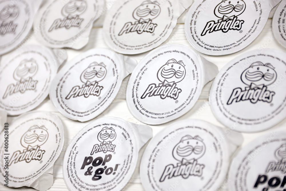 Pringles logo on paper membranes on white wooden table. Pringles is a ...