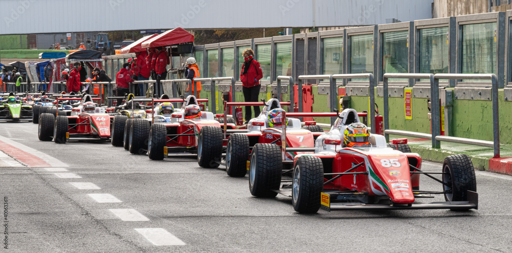 Front view of many racing single seater formula cars aligned in ...