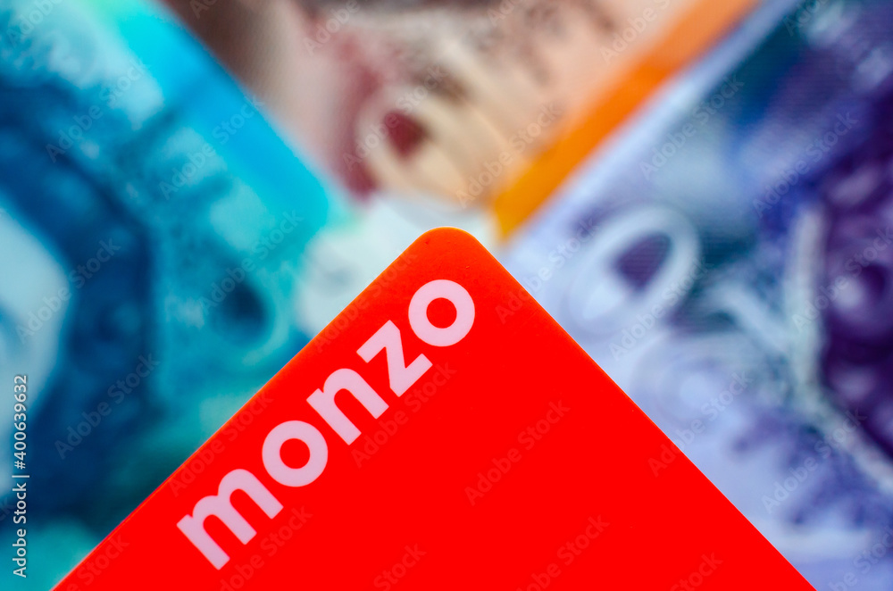 Monzo bank card logo on a vibrant background of blurred British pounds ...
