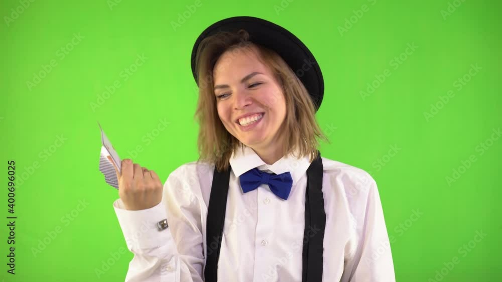 A Woman Dealer in a White Shirt and Hat Tries to Reveal Four Ace Cards ...