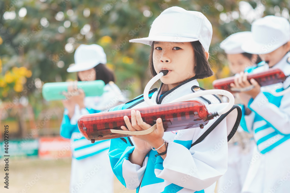 Kids playing music in marching band, cute Asian child blowing ...