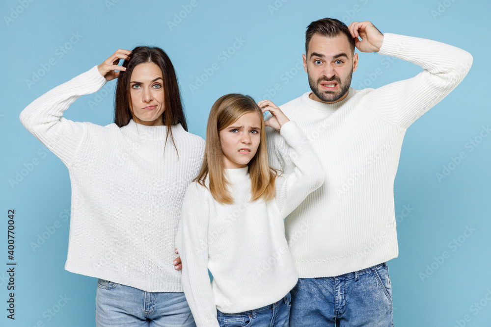 Preoccupied puzzled young parents mom dad with child kid daughter teen ...