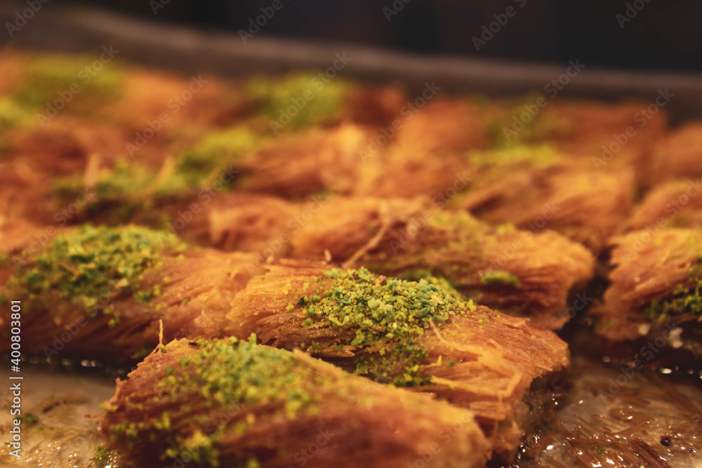 Turkish dessert kunefe, kunafa, kadayif with pistachio powder and ...