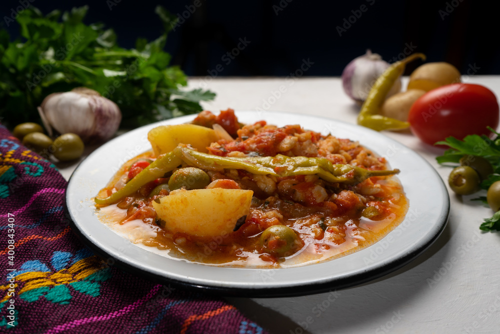 Mexican style cod called a la vizcaina on white background Stock Photo ...