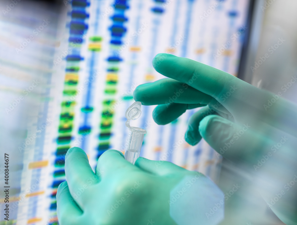 DNA Sciences, Scientist with a sample in a vial ready for automated ...