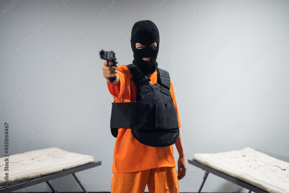 A young girl gets a mask, weapons and body armor and makes an armed ...