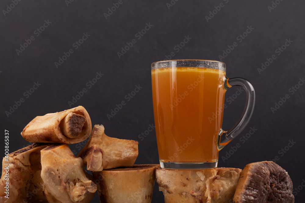 Homemade Beef Bone Broth in mug on dark background. Selective focus ...