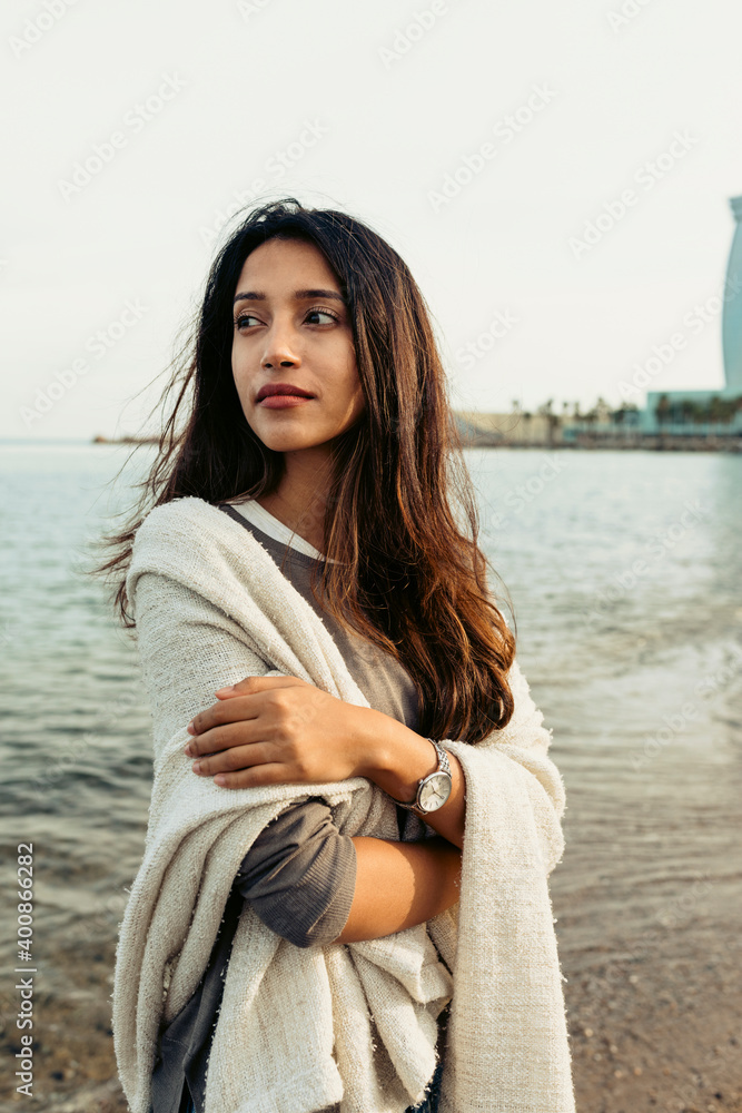 Contemplating woman with arms crossed looking away at beach Stock Photo ...