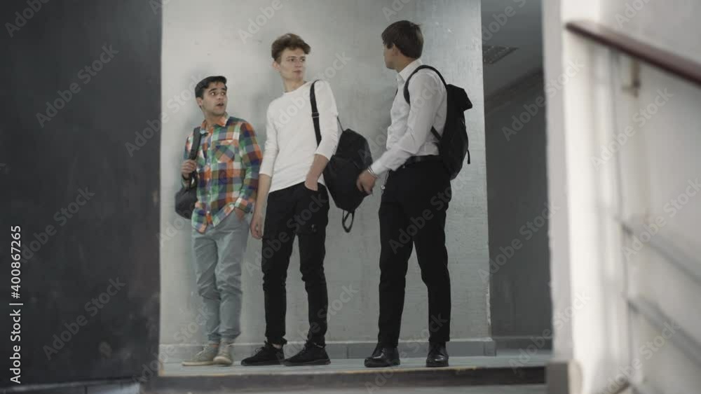 Wide shot portrait of confused embarrassed high school student standing ...