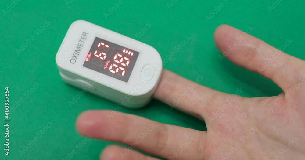 Symptoms and signs of COVID-19. Closeup hand of person measuring the ...