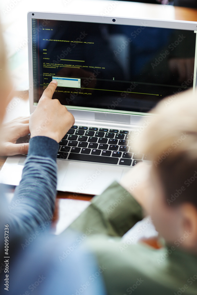 Over the shoulder view of two unrecognizable school kids learning how ...