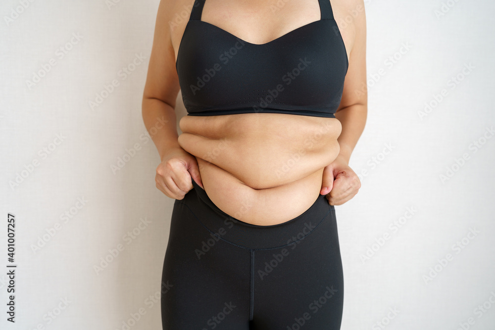Women body fat belly. Obese woman hand holding excessive belly fat. diet lifestyle concept to ...