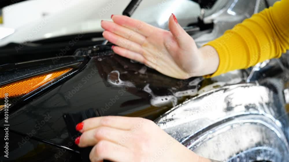 Close up to PPF installation process on a front rear headlight and ...