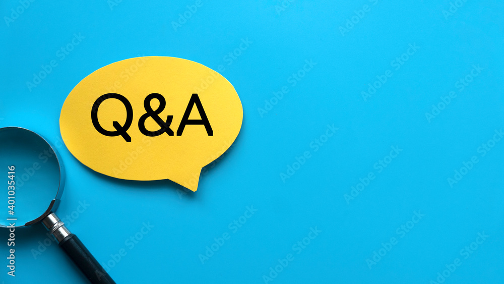 Top view of magnifying glass and yellow speech bubble written with Q&A Question and Answer on ...