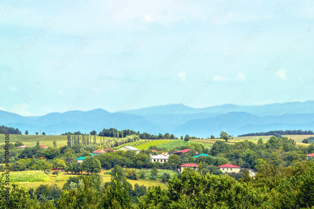 Rural village in the Republic of Georgia with Cacuses mountains in the ...