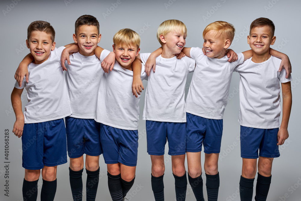 soccer team, kids in uniform posing at camera. friendly and strong ...