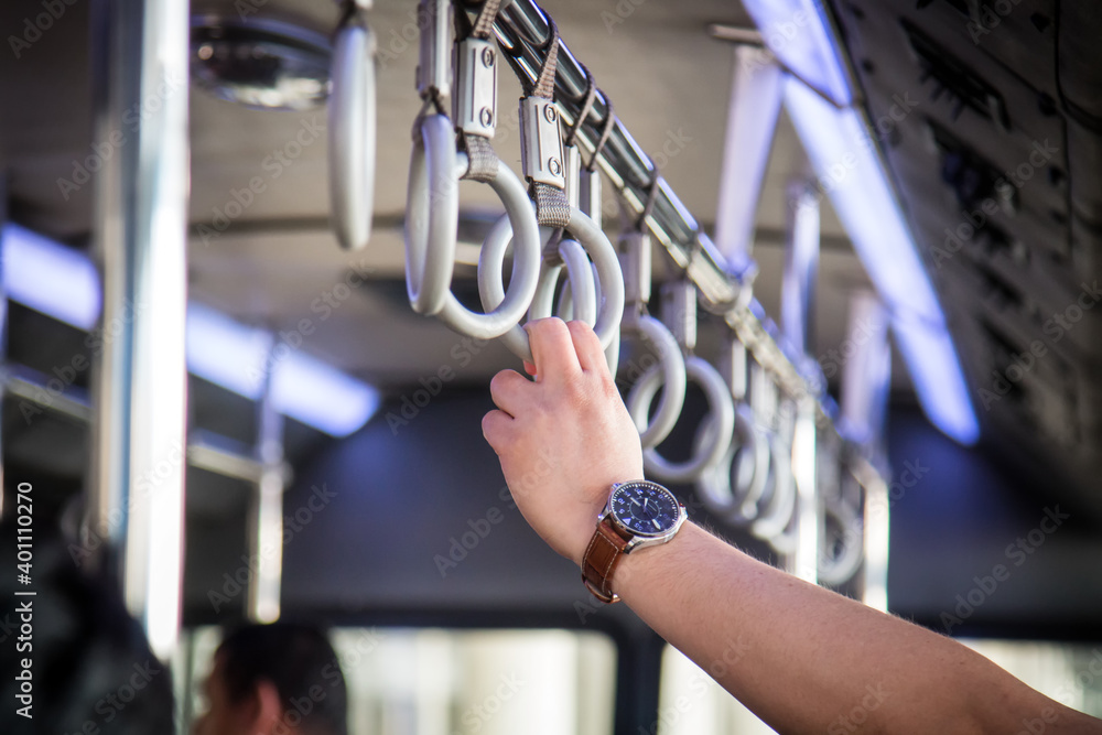 Hand of passenger holding in shuttle bus during transfer to aircraft ...