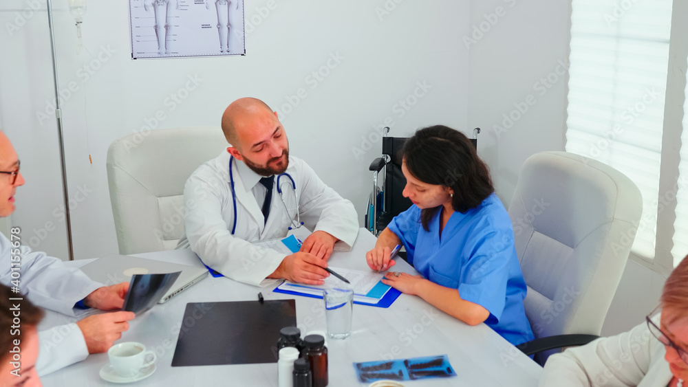 Medical expert talking with medical staff during healthcare meeting in ...