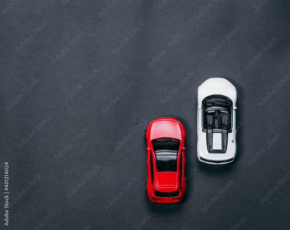 Two premium sport car models in studio light on black paper background ...