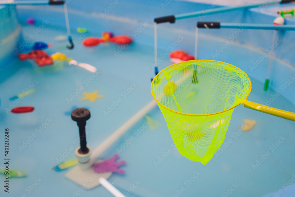 fishing in the paddling pool. Children's toys in the pool. Toy fish ...
