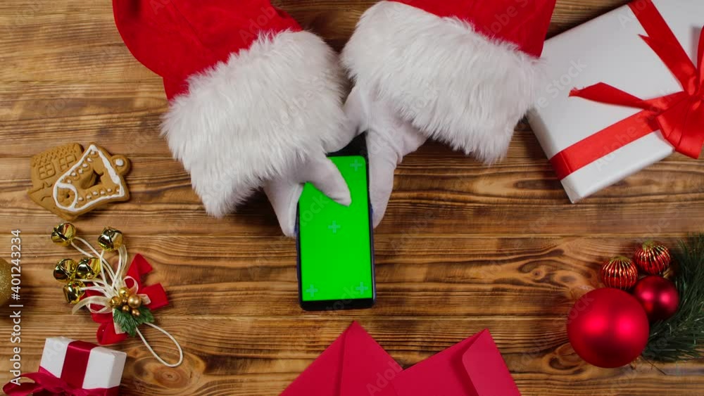 Top view Santa hands uses smartphone with green screen chroma key by ...