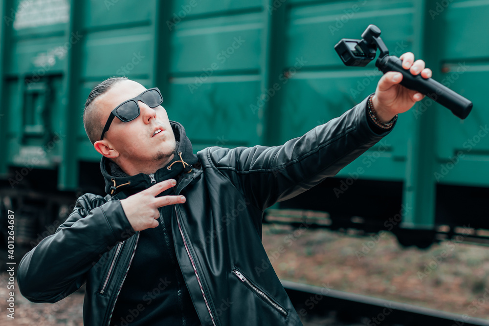 Handsome Guy in Black Clothes and Sunglasses Making Selfie or Streaming ...