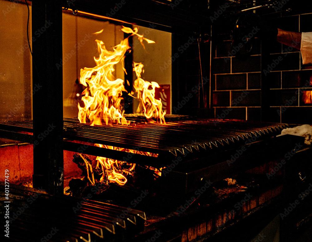 Foto de Professional metal grill with burning fire for traditional ...