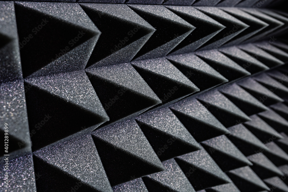 Textured background of wall with black geometric soundproof foam with ...